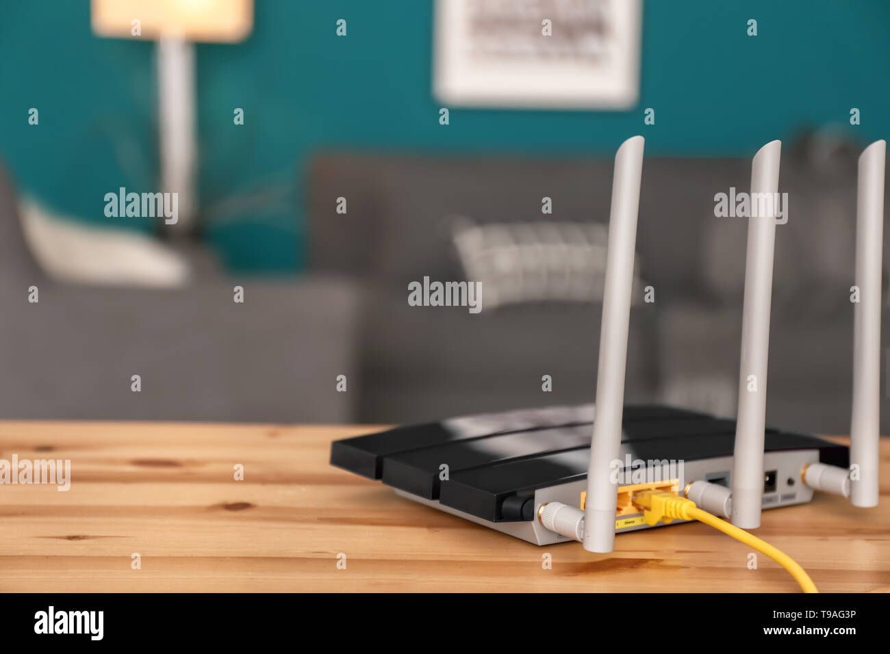 Modern wi-fi router on wooden table in room Stock Photo - Alamy