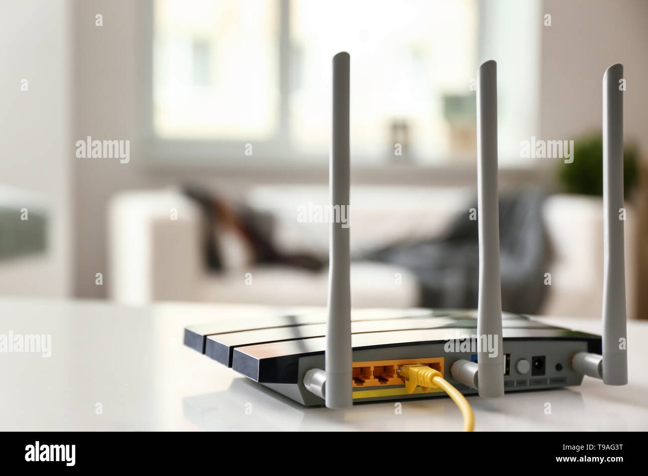 Modern wi-fi router on light table in room Stock Photo - Alamy