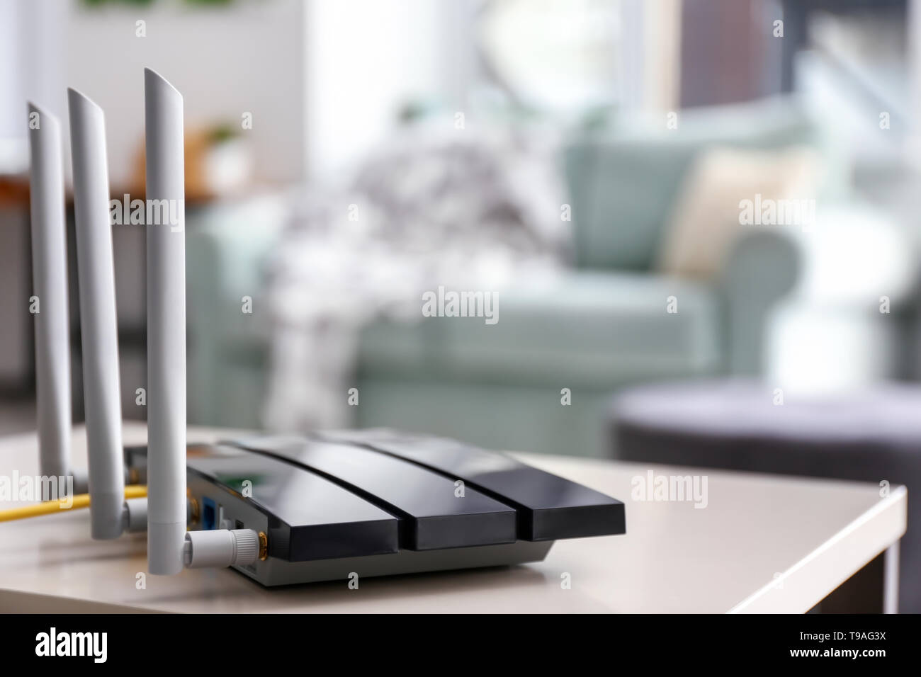 Modern wi-fi router on light table in room Stock Photo - Alamy
