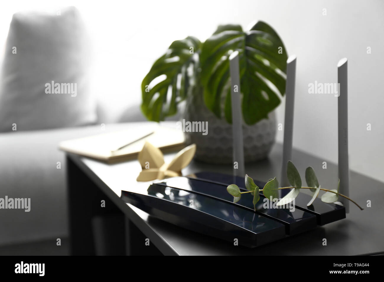 Modern wi-fi router on dark table in room Stock Photo - Alamy