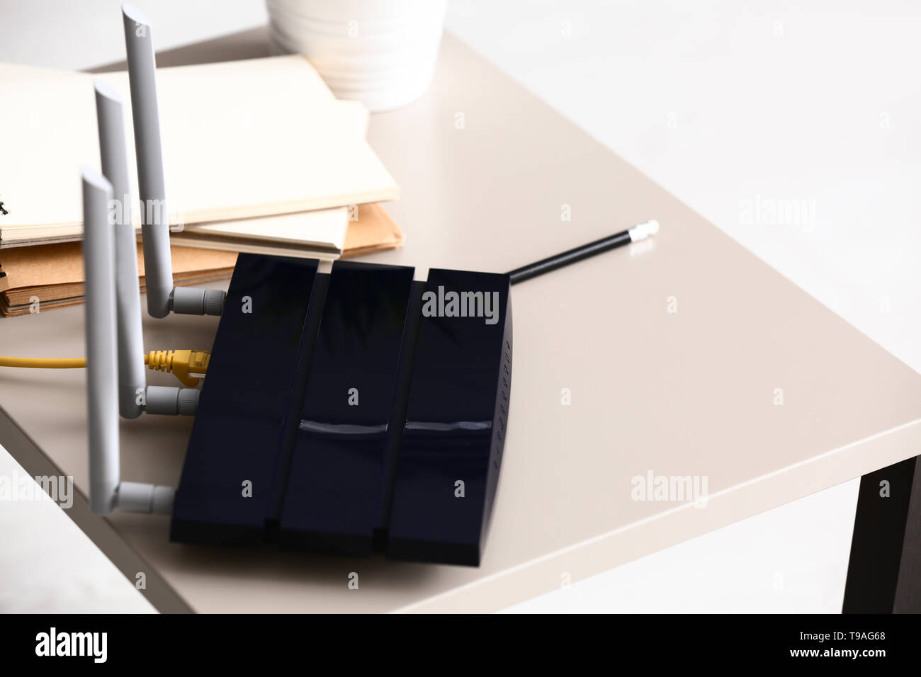 Modern wi-fi router on light table in office Stock Photo - Alamy