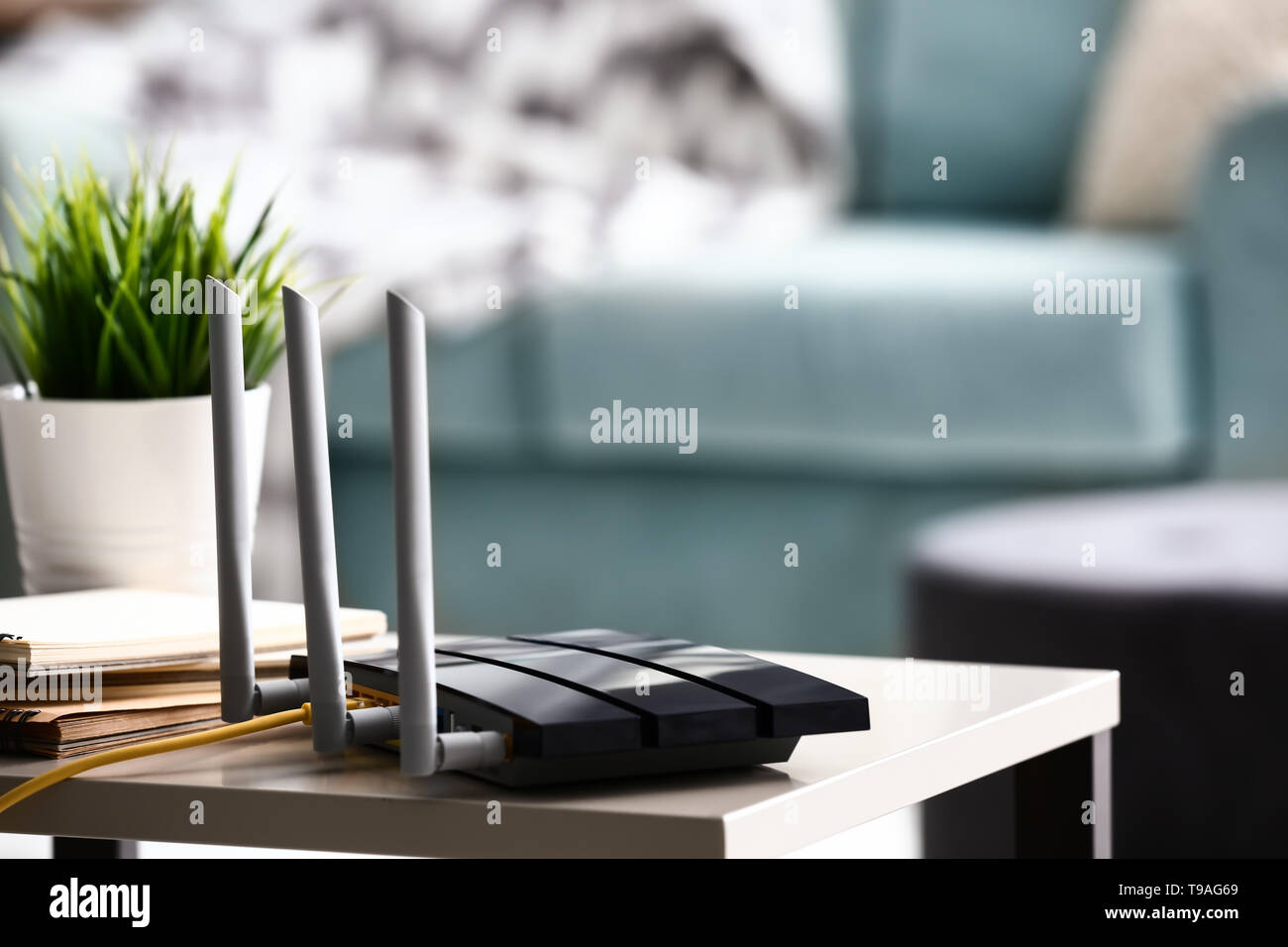 Modern wi-fi router on light table in room Stock Photo - Alamy