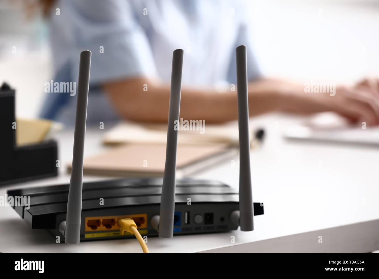 Modern wi-fi router on light table in office Stock Photo - Alamy