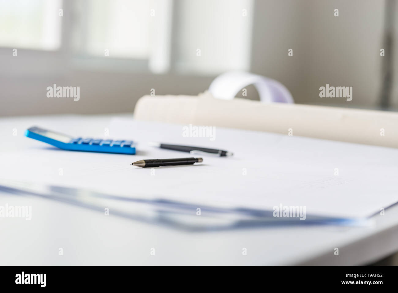 Pencil, calculator and ruler on an architectural or designer project ...