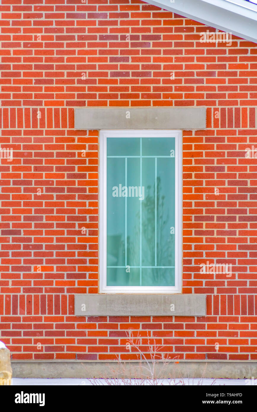 Close up of the rectangular window of a building with red brick wall ...