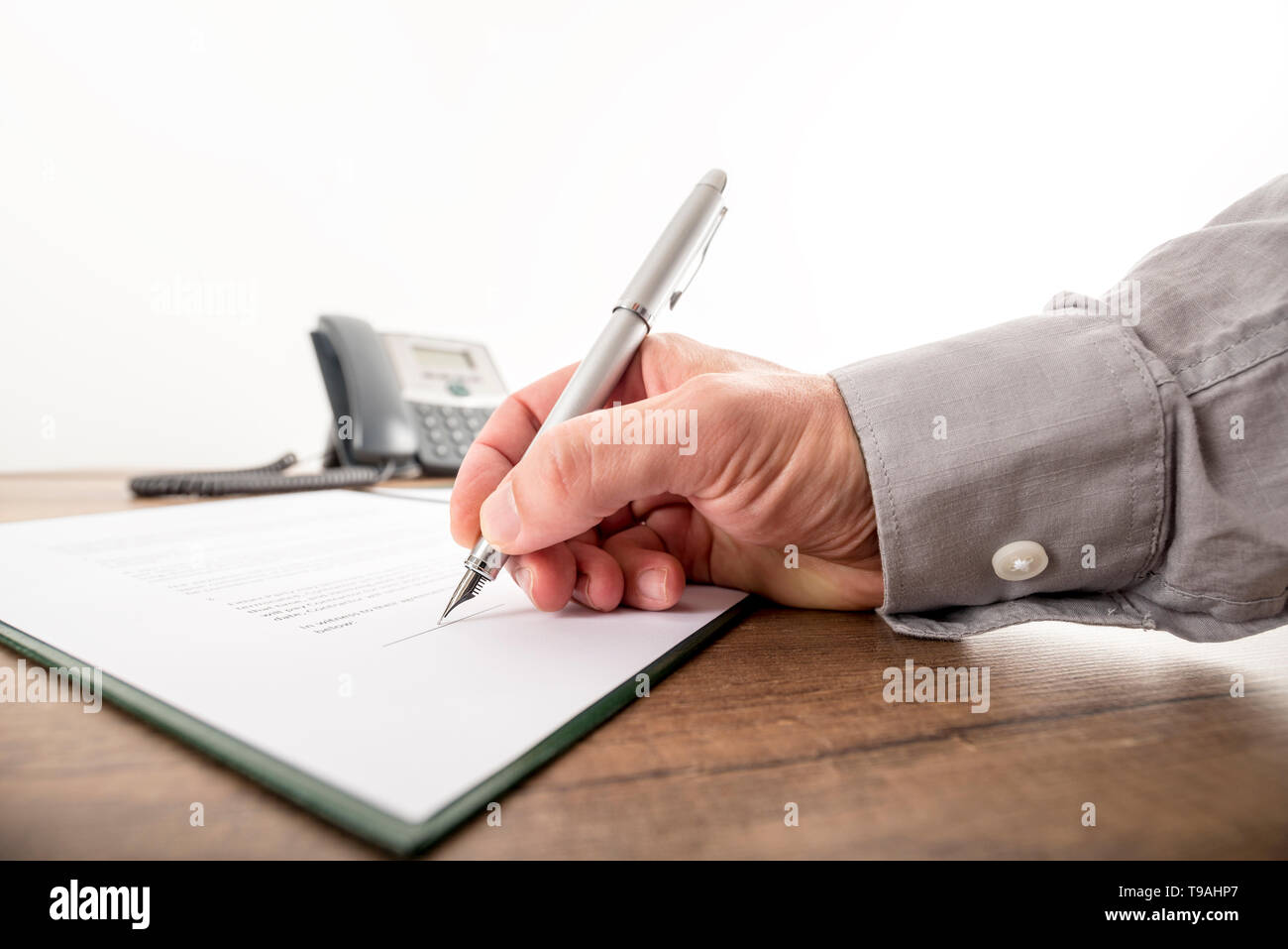 Closeup of businessman or lawyer signing an important contract ...