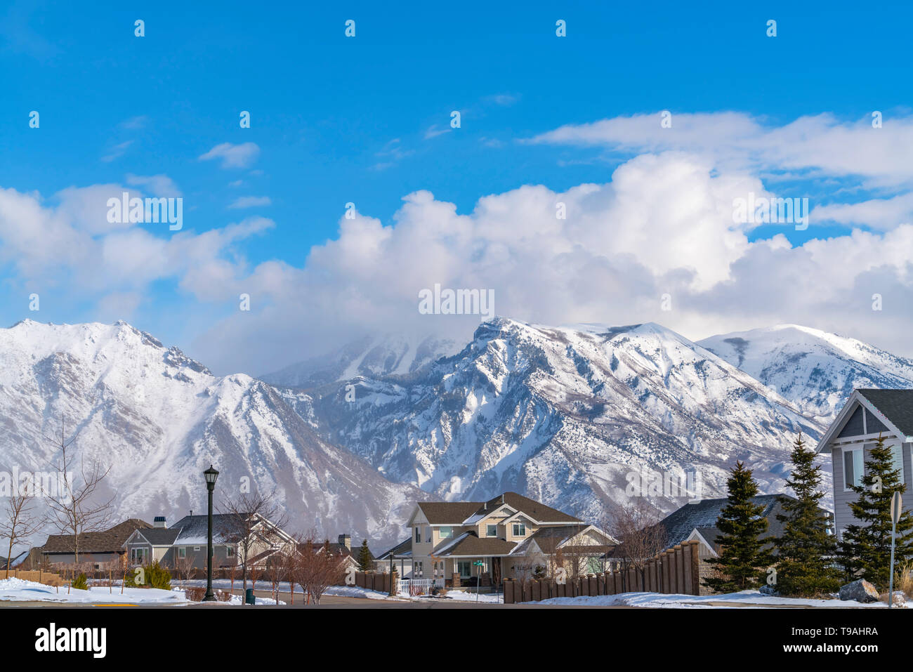 Beautiful homes against a magnificent snow covered mountain in winter ...