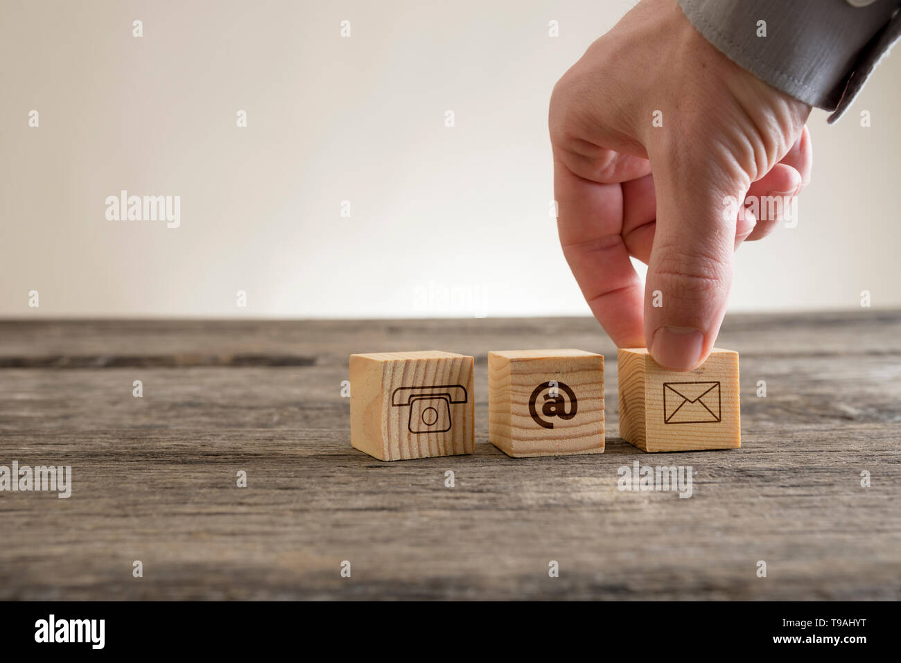 Cubes with contact symbols - envelope, at sign and telephone being ...