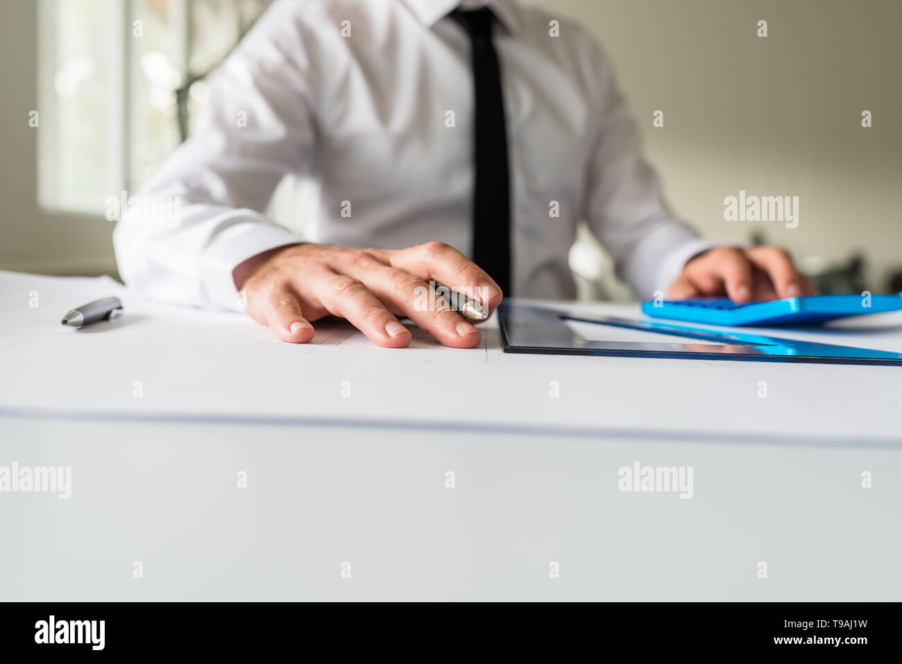 Designer or architect working on a project drawing a draft, using ...