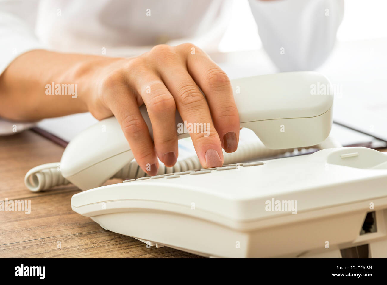 Hand holding landline phone hi-res stock photography and images - Alamy