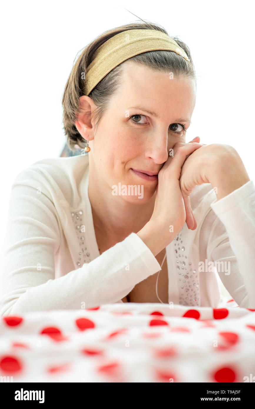 Friendly attractive charismatic young woman lying on a red and white ...