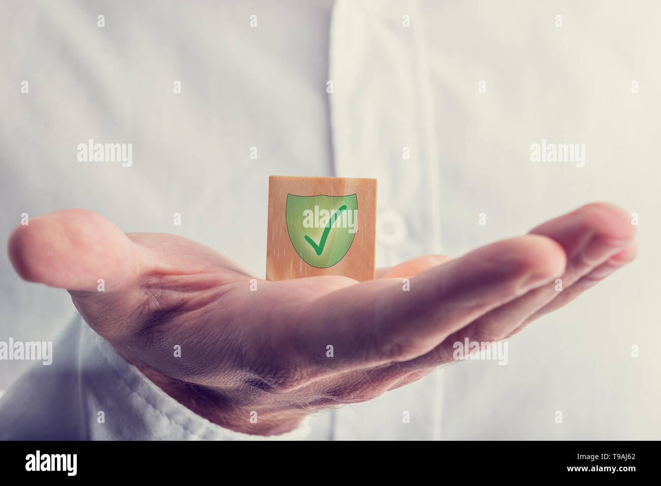 Hand check mark shield hi-res stock photography and images - Alamy
