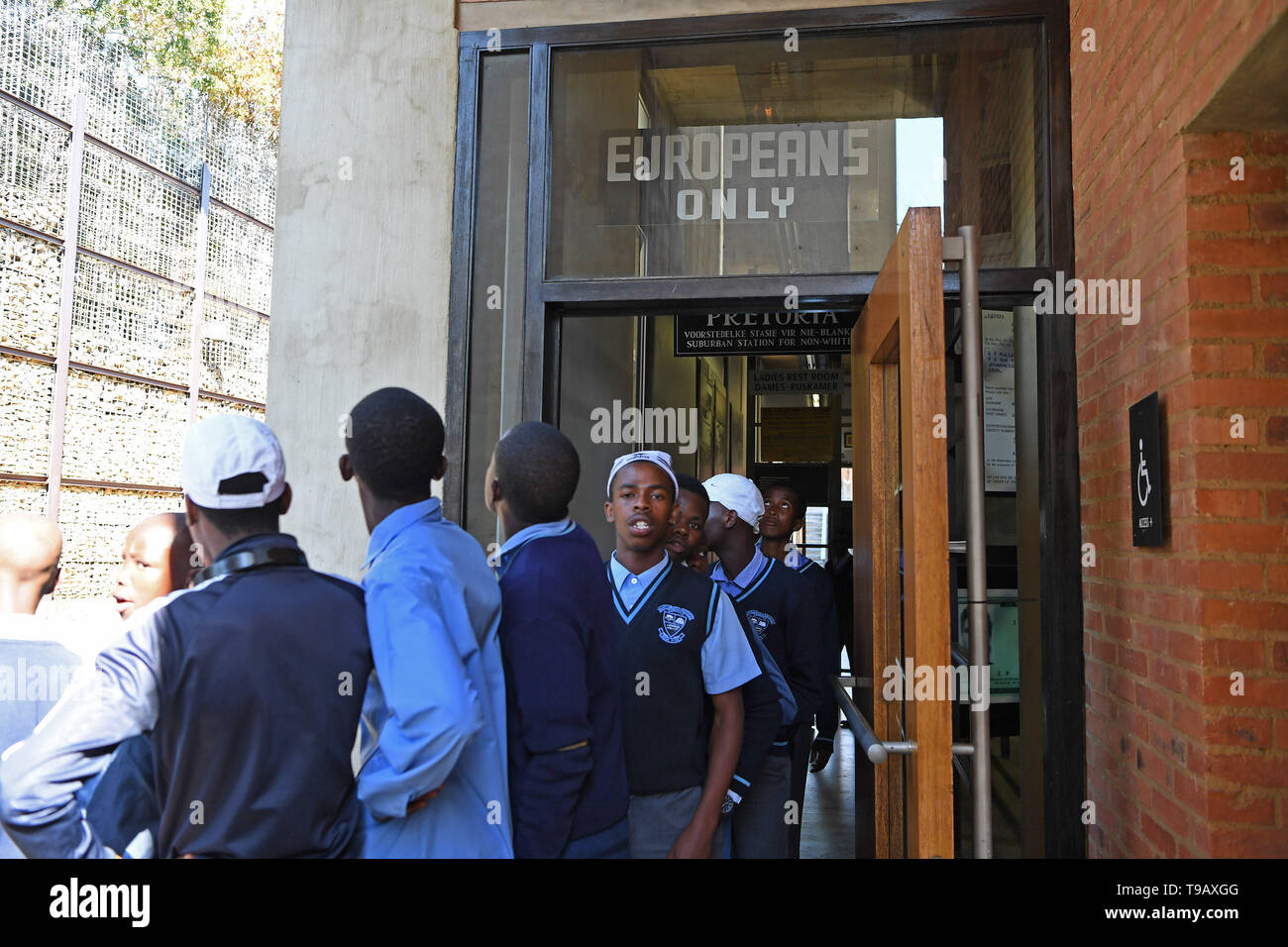 Beijing, South Africa. 17th May, 2019. People walk through a door ...