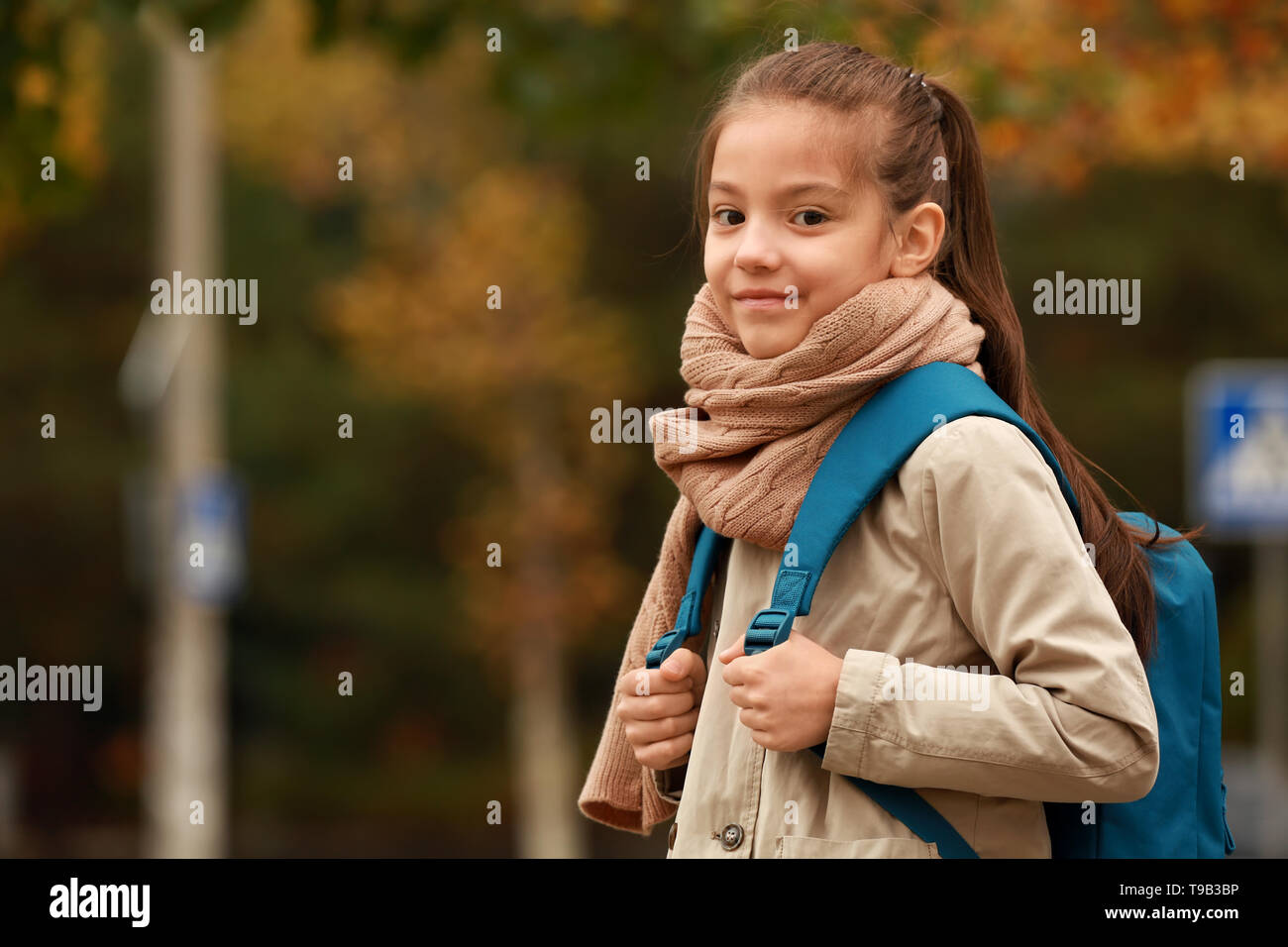 Cute girl with backpack outdoors Stock Photo - Alamy