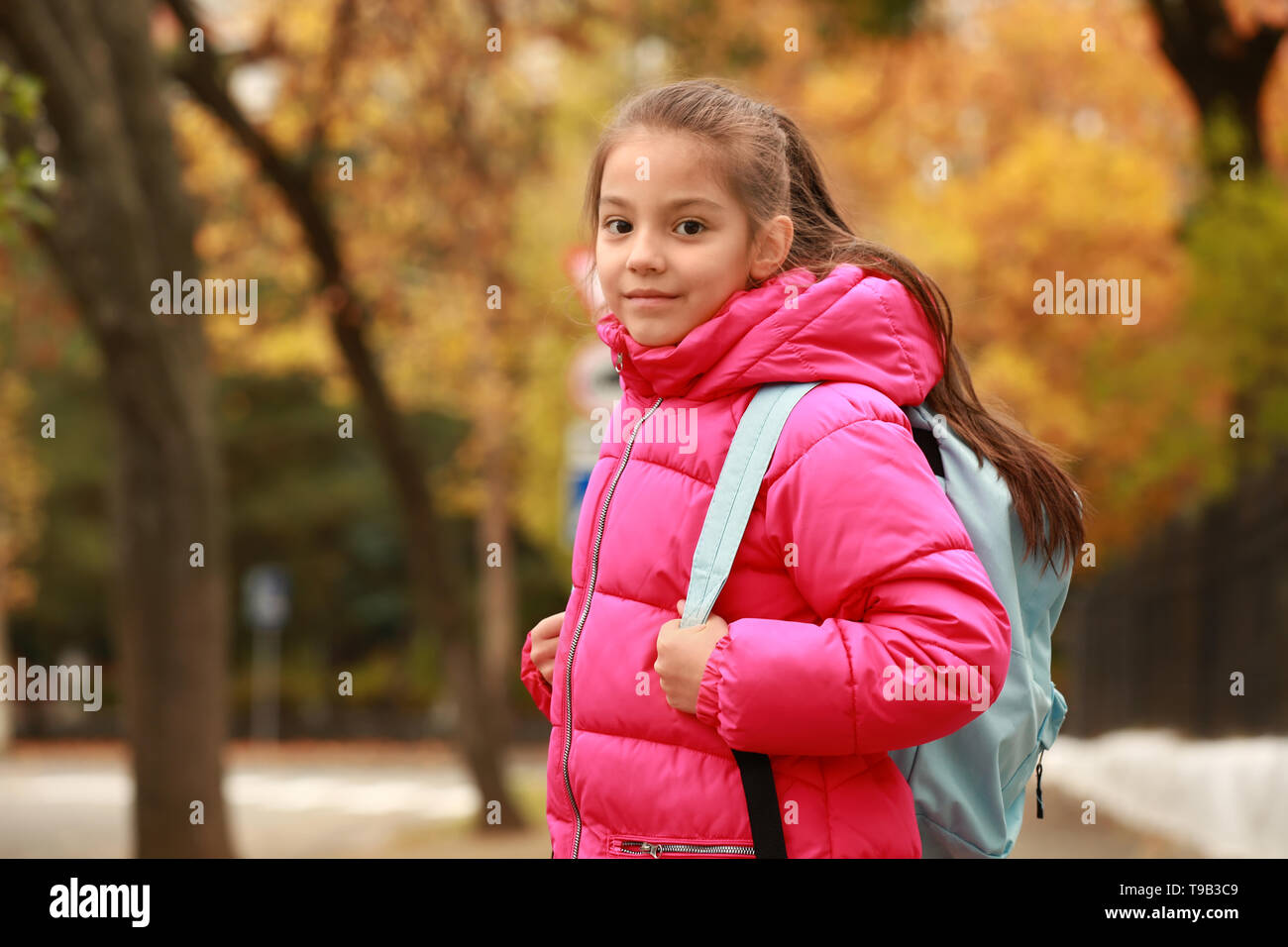 Cute girl with backpack outdoors Stock Photo - Alamy