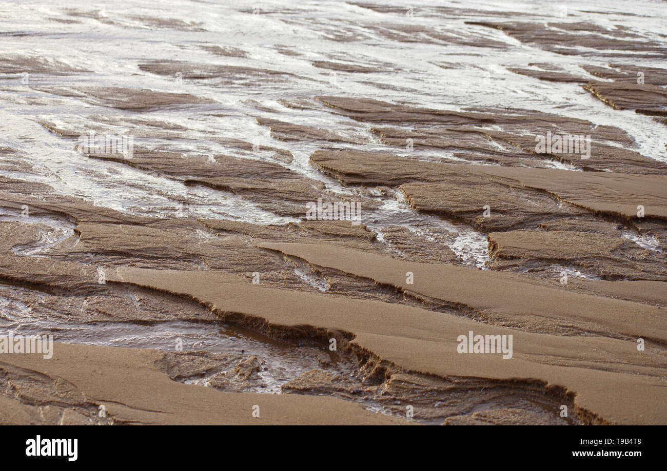 Coastal retreating tide water channels through sand texture pattern ...