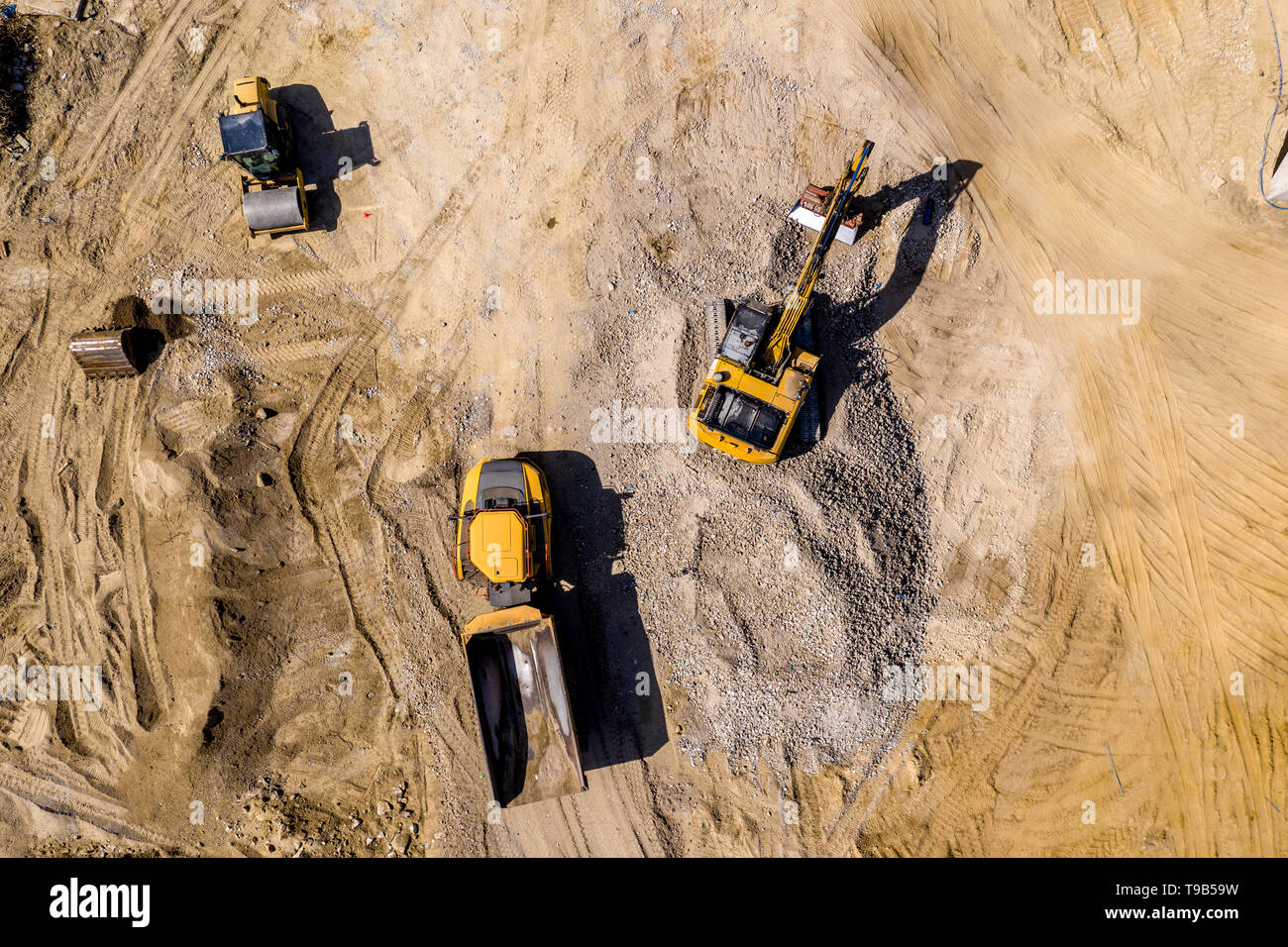 Industrial truck loader excavator moving earth and unloading. Aerial ...