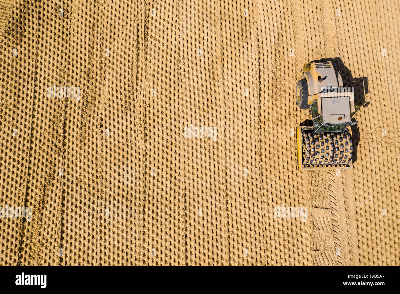 Aerial View. Roller steamroller or vibratory roller machine working on ...