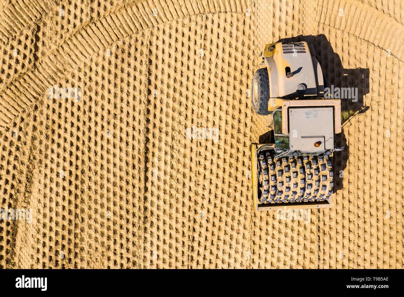 Aerial View. Roller steamroller or vibratory roller machine working on ...