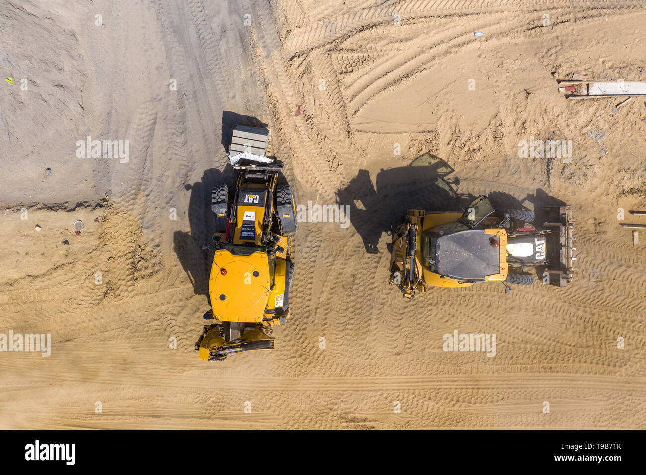 Industrial truck loader excavator moving earth and unloading. Aerial ...