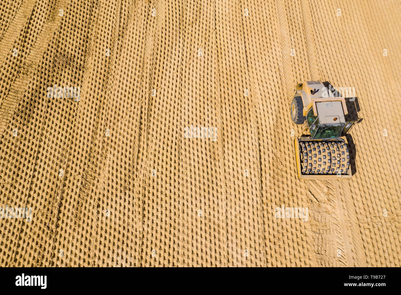 Aerial View. Roller steamroller or vibratory roller machine working on ...