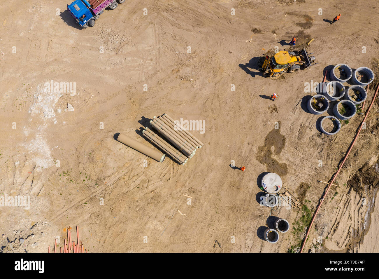 Industrial truck loader excavator moving earth and unloading. Aerial ...