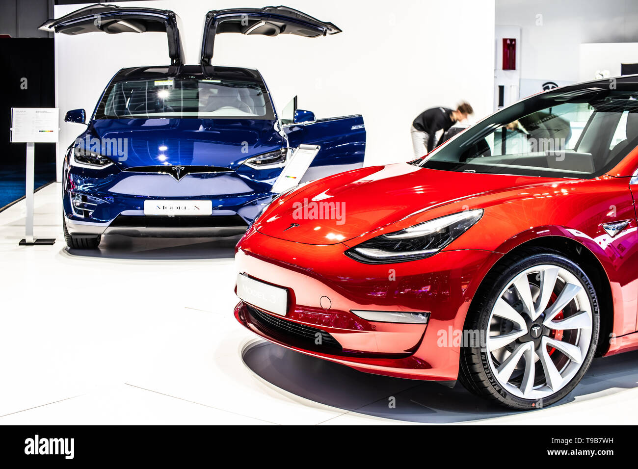 Brussels, Belgium, Jan 18, 2019: metallic red Tesla Model 3 and blue ...