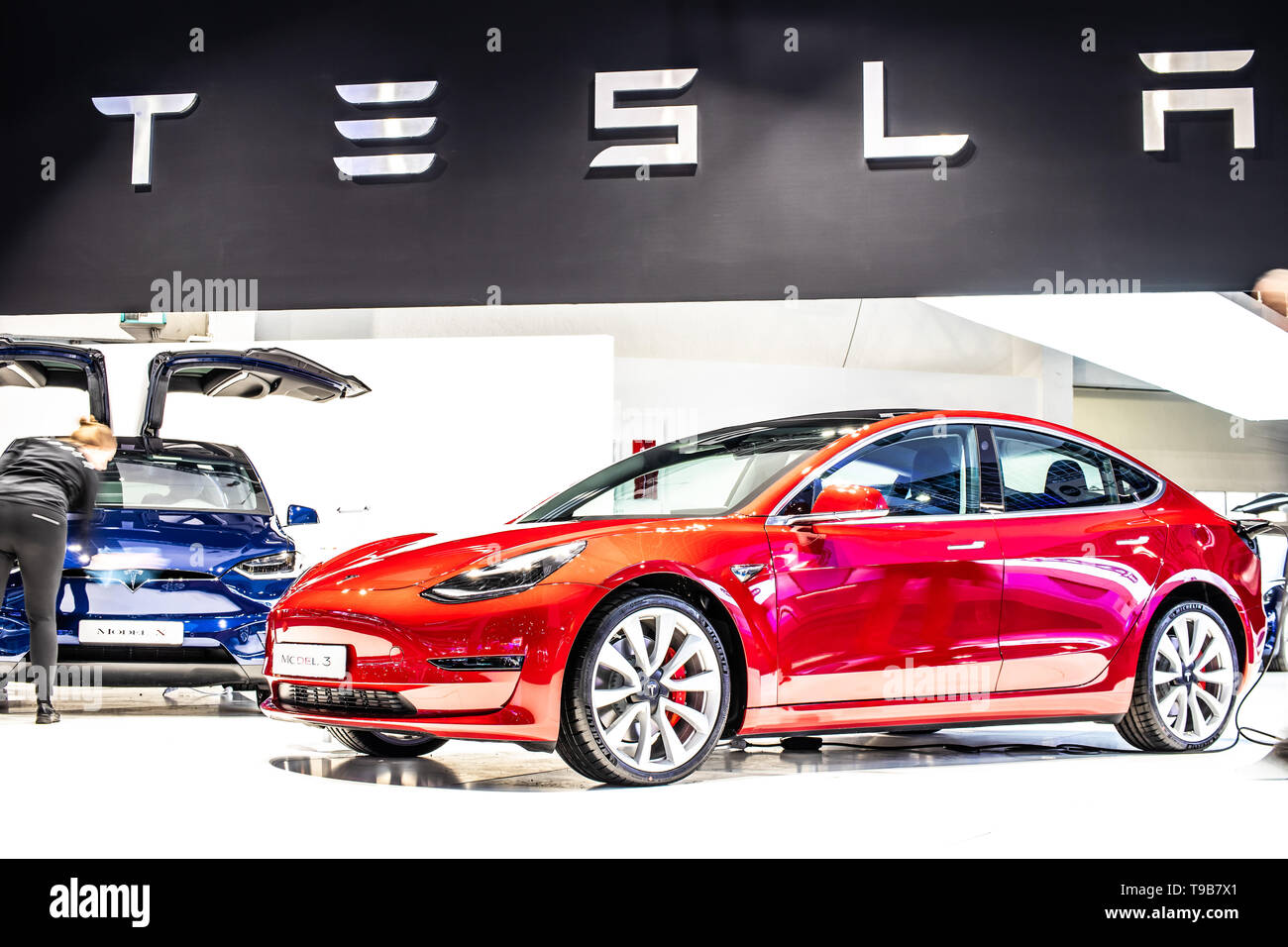 Brussels, Belgium, Jan 18, 2019: metallic red Tesla Model 3 and blue ...