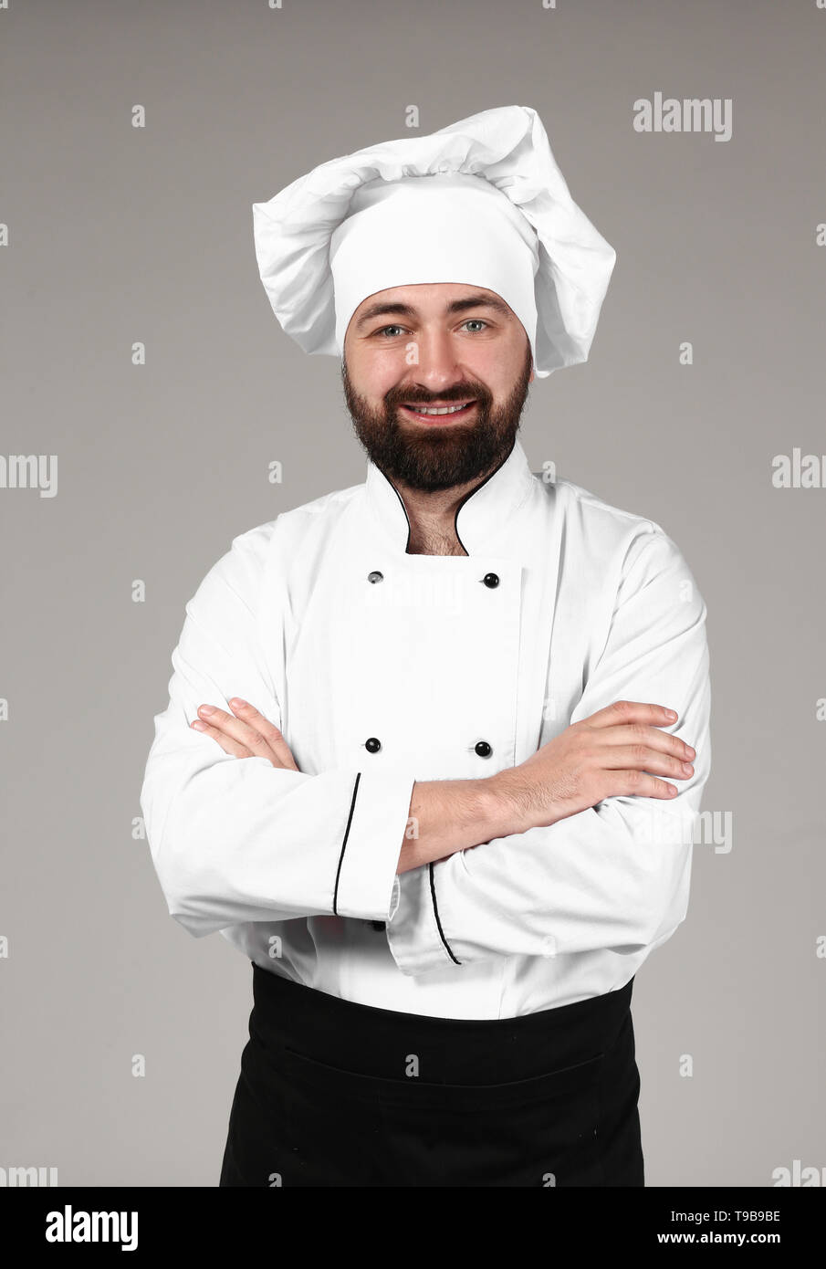 Male chef on grey background Stock Photo - Alamy