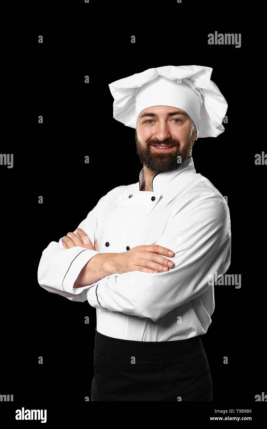 Male chef on dark background Stock Photo - Alamy