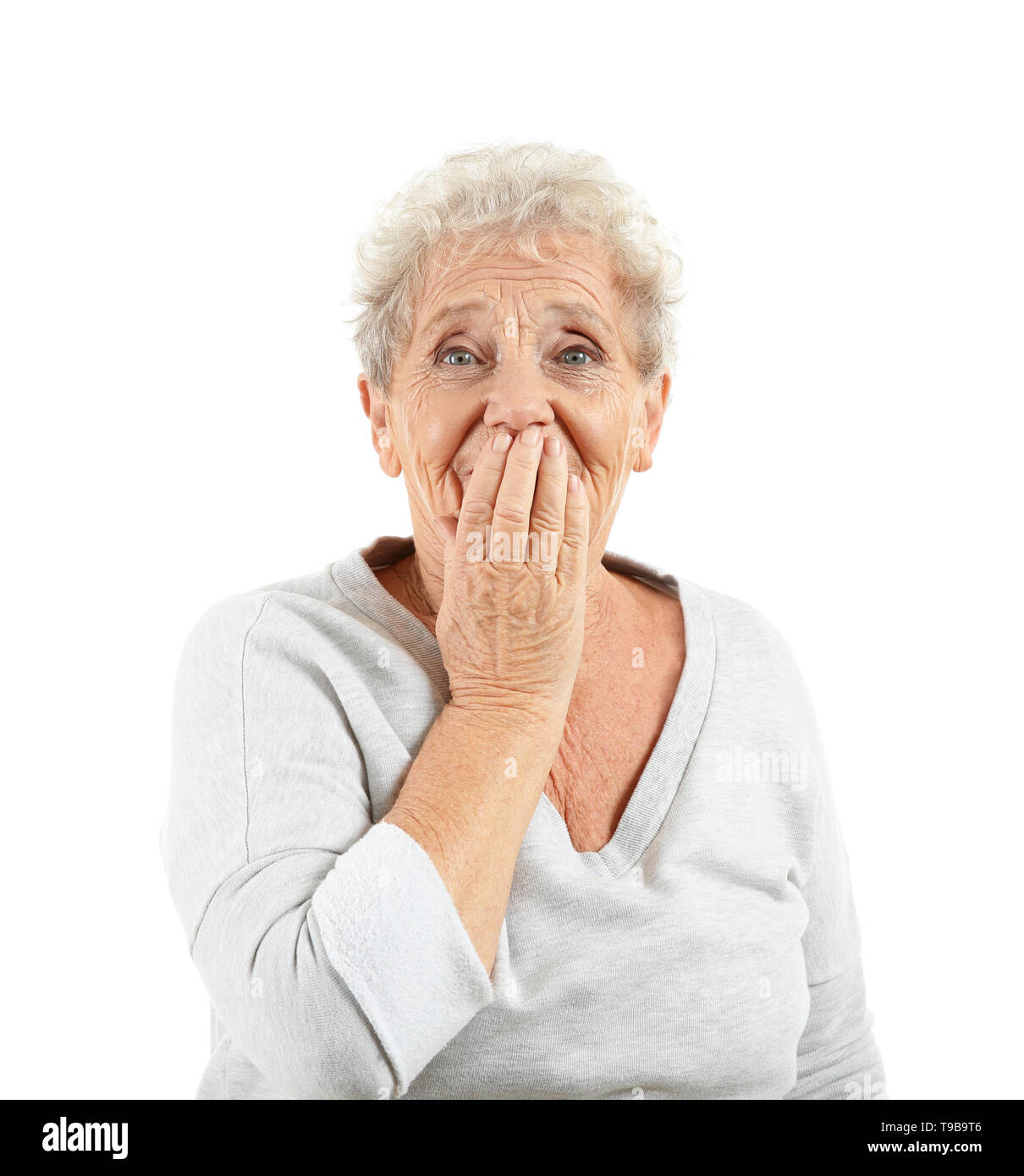 Portrait of elderly woman after making mistake on white background ...