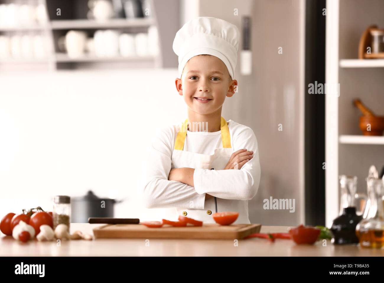 Cute little chef in kitchen Stock Photo - Alamy