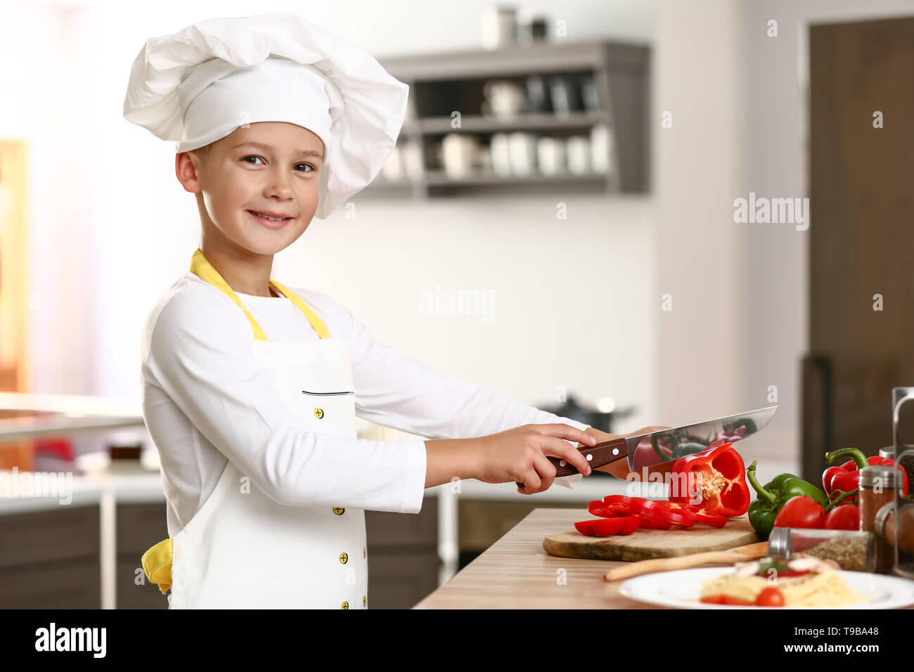 Cute little chef cooking in kitchen Stock Photo - Alamy