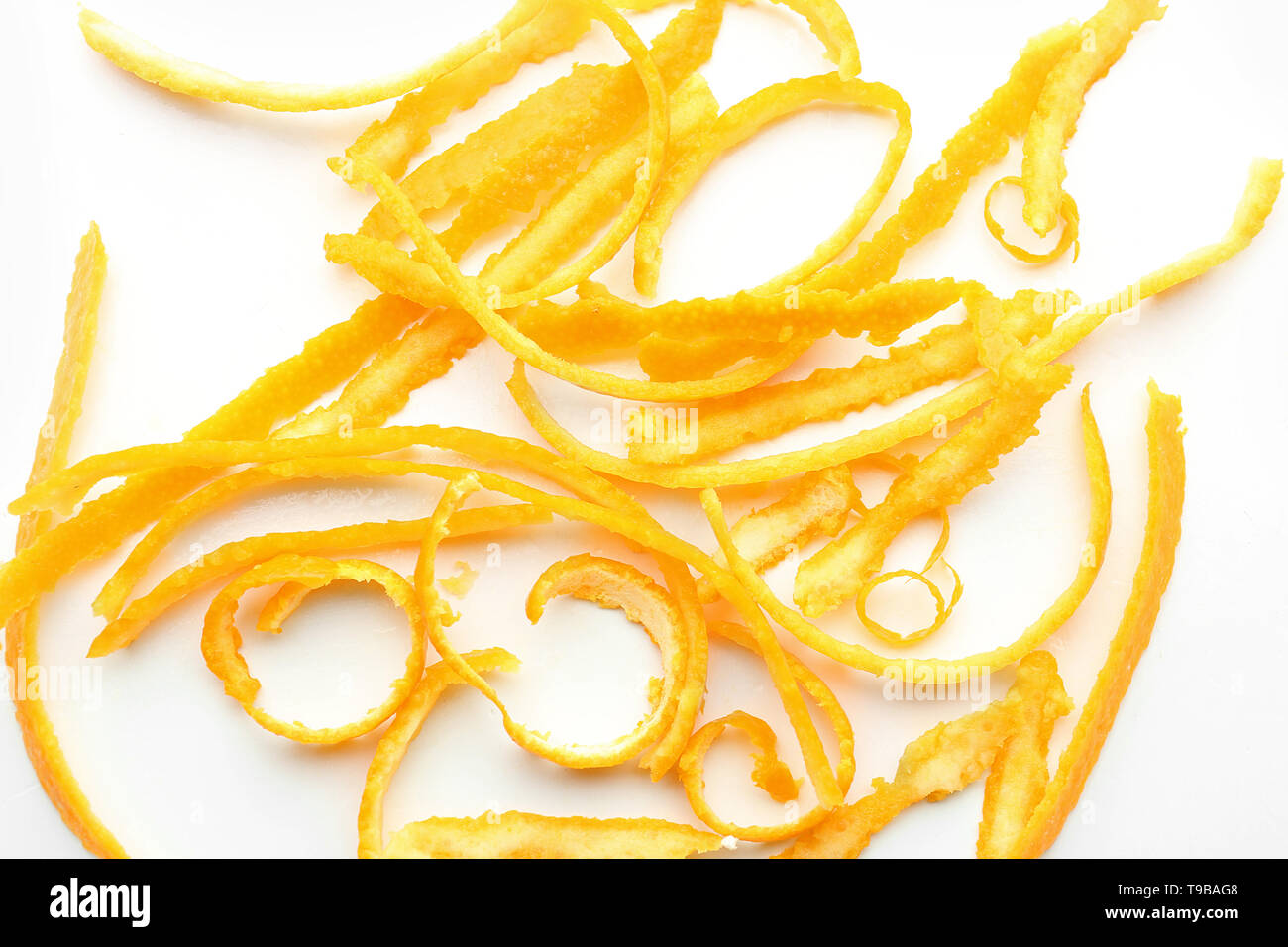 Orange zest on white background Stock Photo - Alamy
