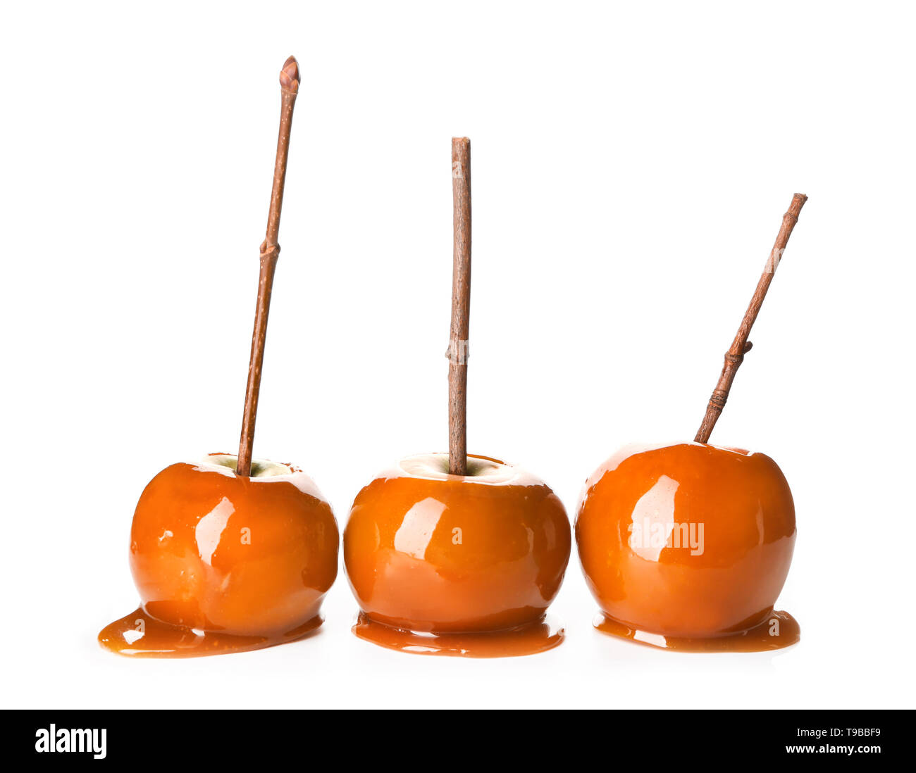 Delicious caramel apples with tree branches on white background Stock ...