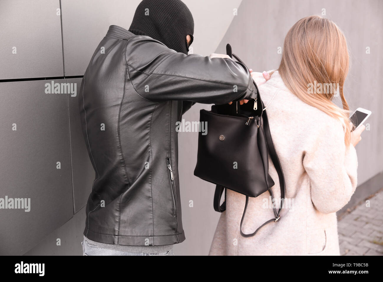 Thief stealing phone from bag hi-res stock photography and images - Alamy