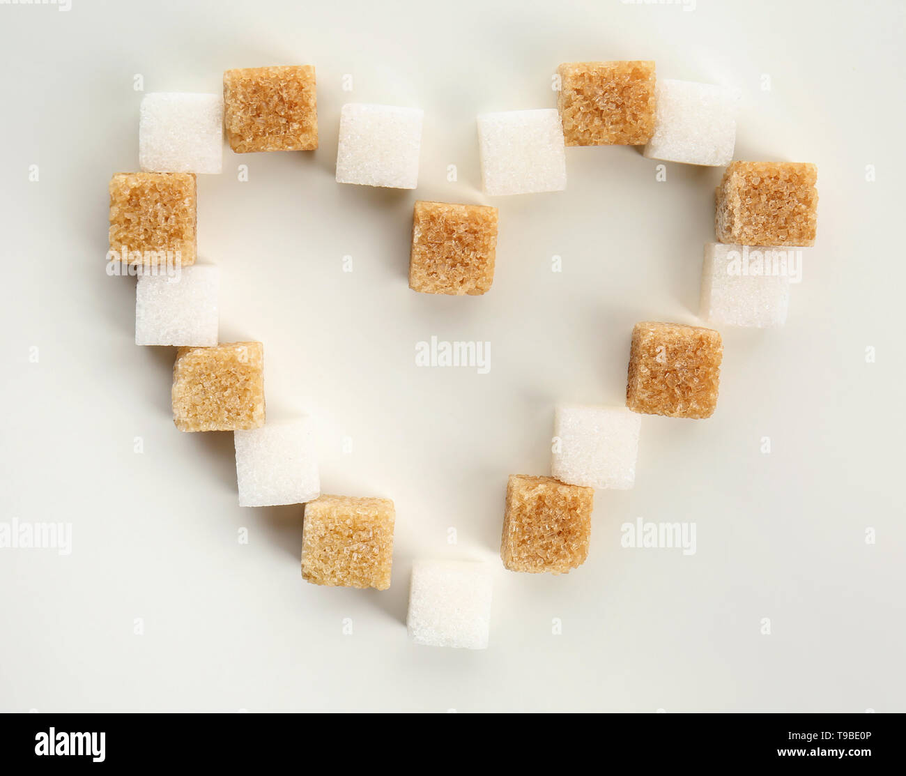 Heart made with different cubes of sugar on white background Stock ...