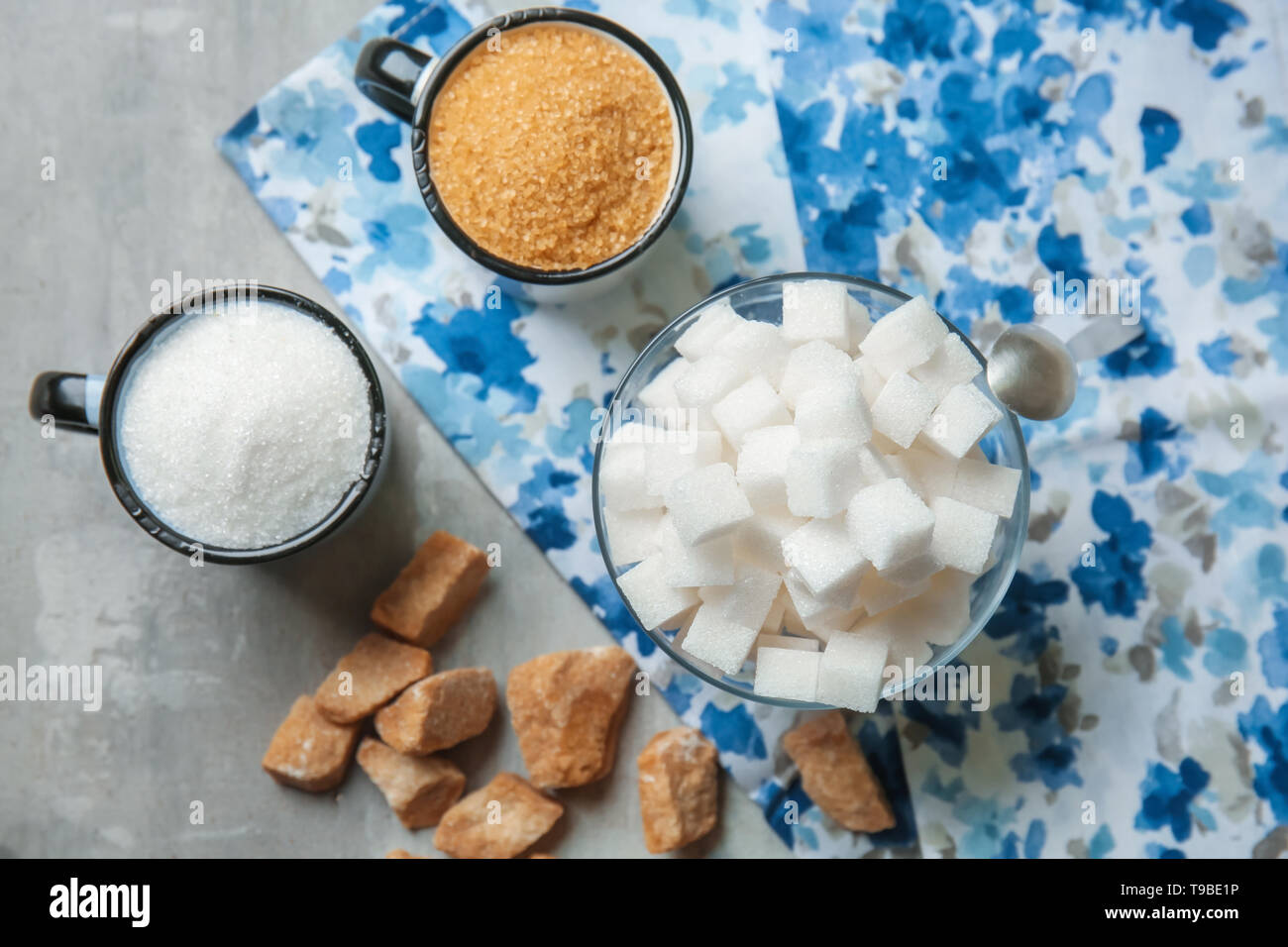 Different kinds of sugar on grey table Stock Photo - Alamy