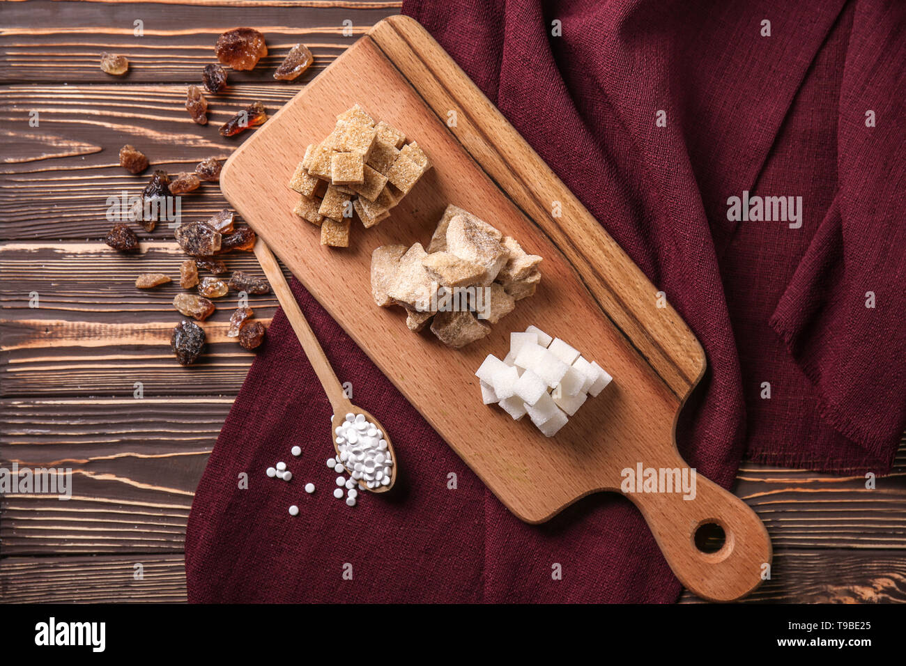 Different kinds of sugar on wooden board Stock Photo - Alamy