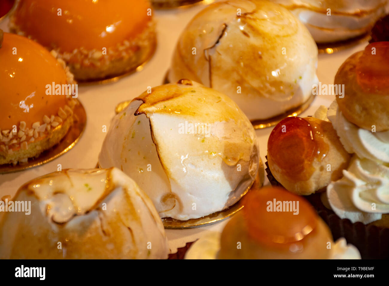 Freshly baked stuffed sweet pastries Orange Lactee and Dome Citron with ...
