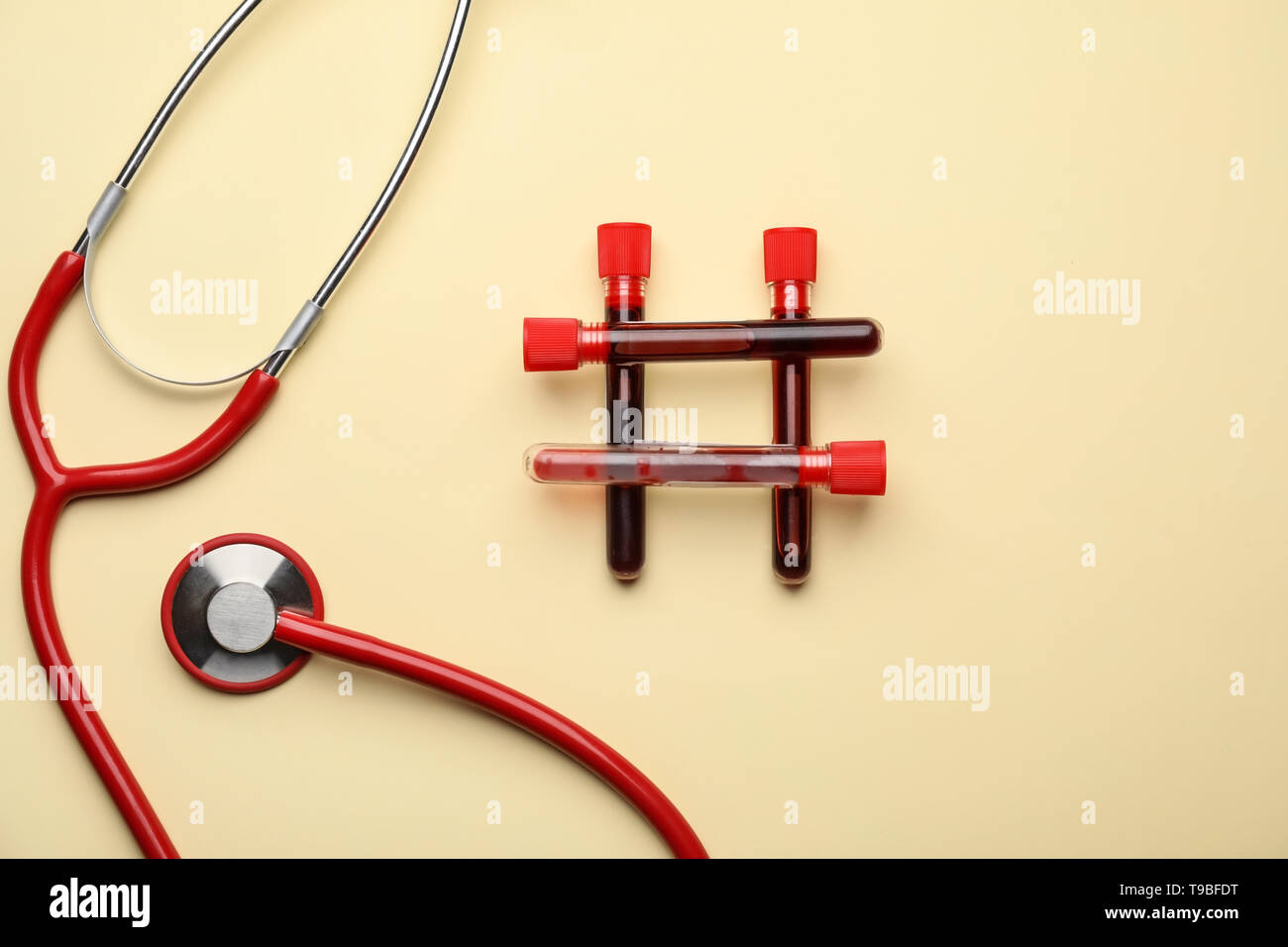Hashtag sign made of blood samples and stethoscope on color background ...