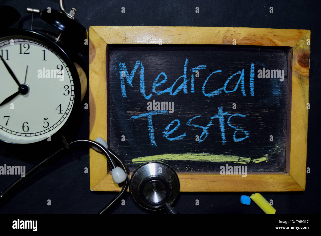 The words Medical Tests handwriting on chalkboard on top view. Alarm ...