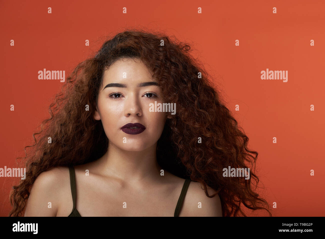 Curly hair woman studio hi-res stock photography and images - Alamy
