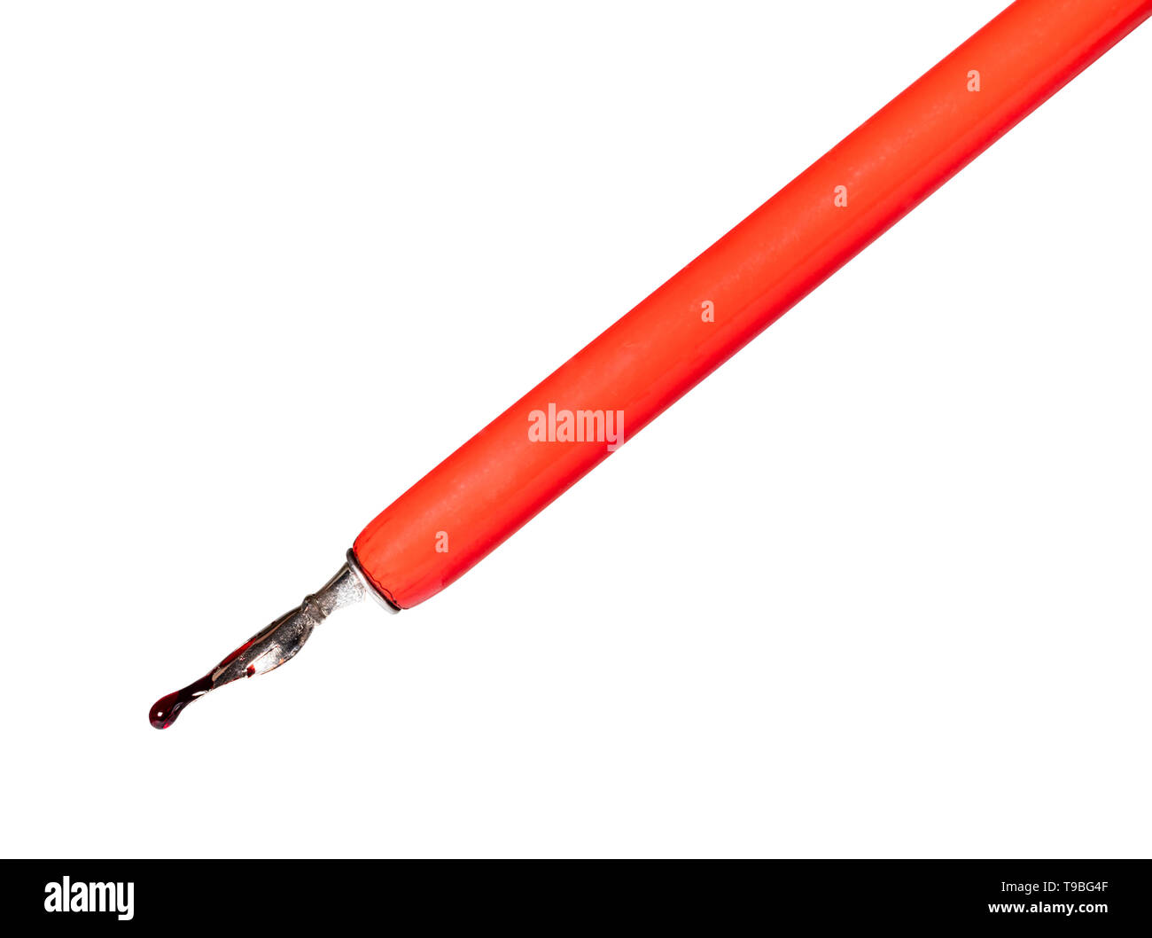 side view of red ink drop on sharp tip of dip pen cut out on white ...