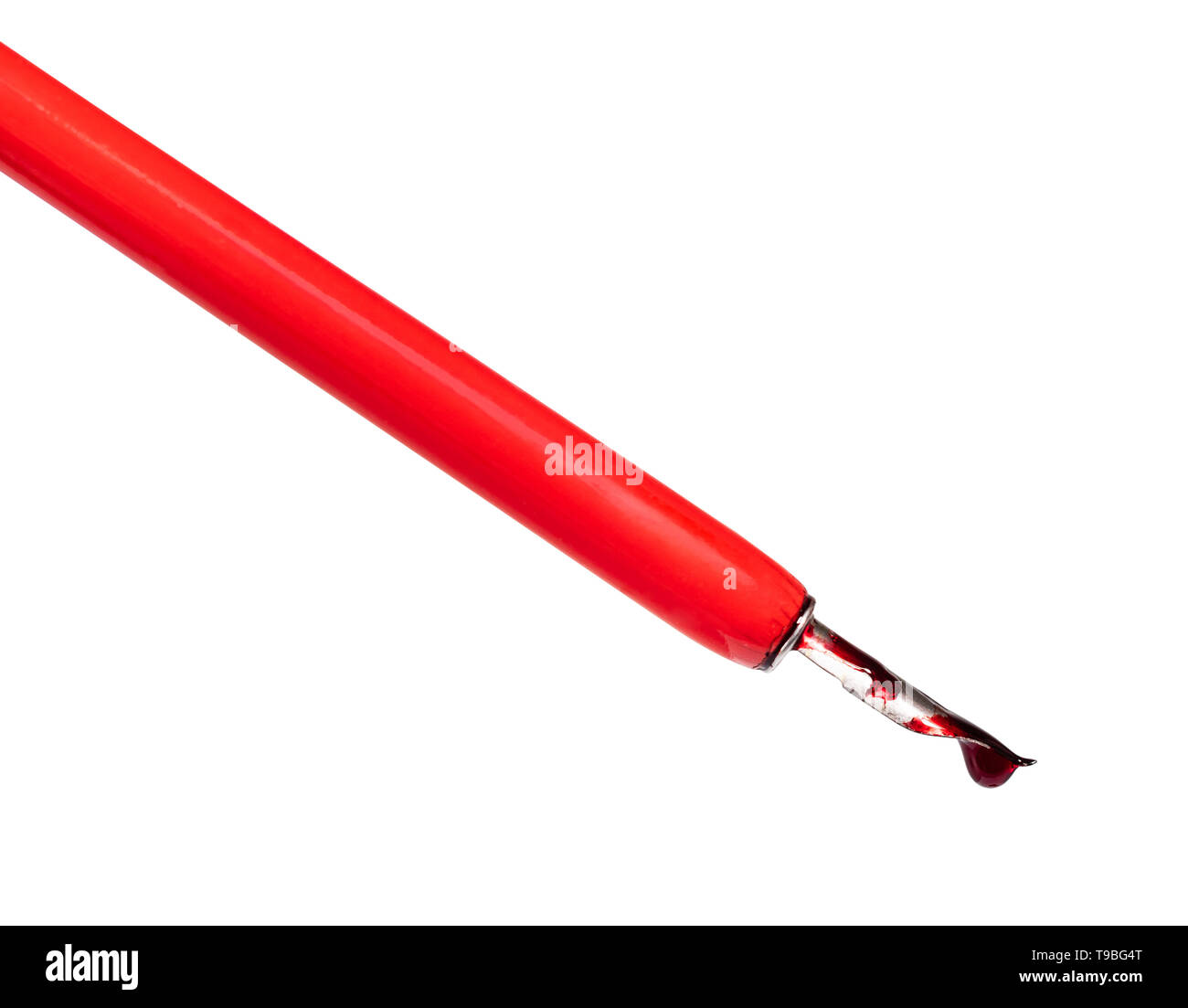 side view of red ink drop flowing from pointed tip of dip pen cut out ...