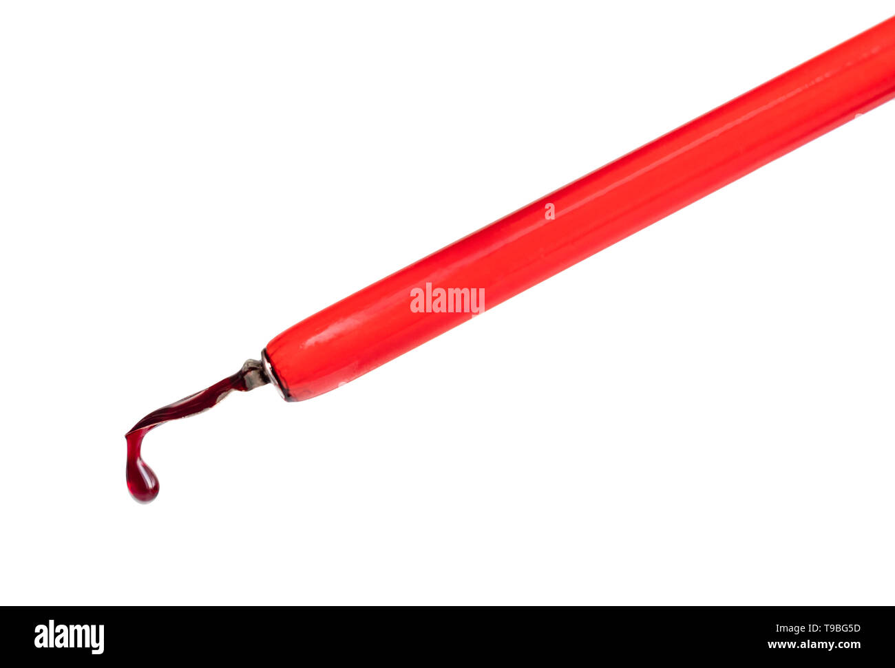side view of big red ink drop is hanging on the tip of dip pen cut out ...