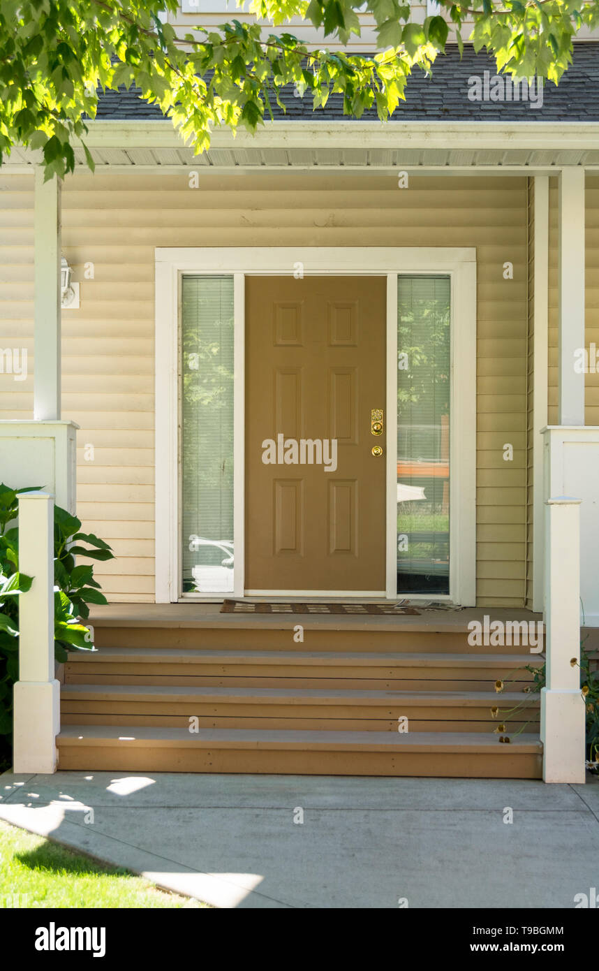 Door steps and concrete pathway leading to residential house main ...