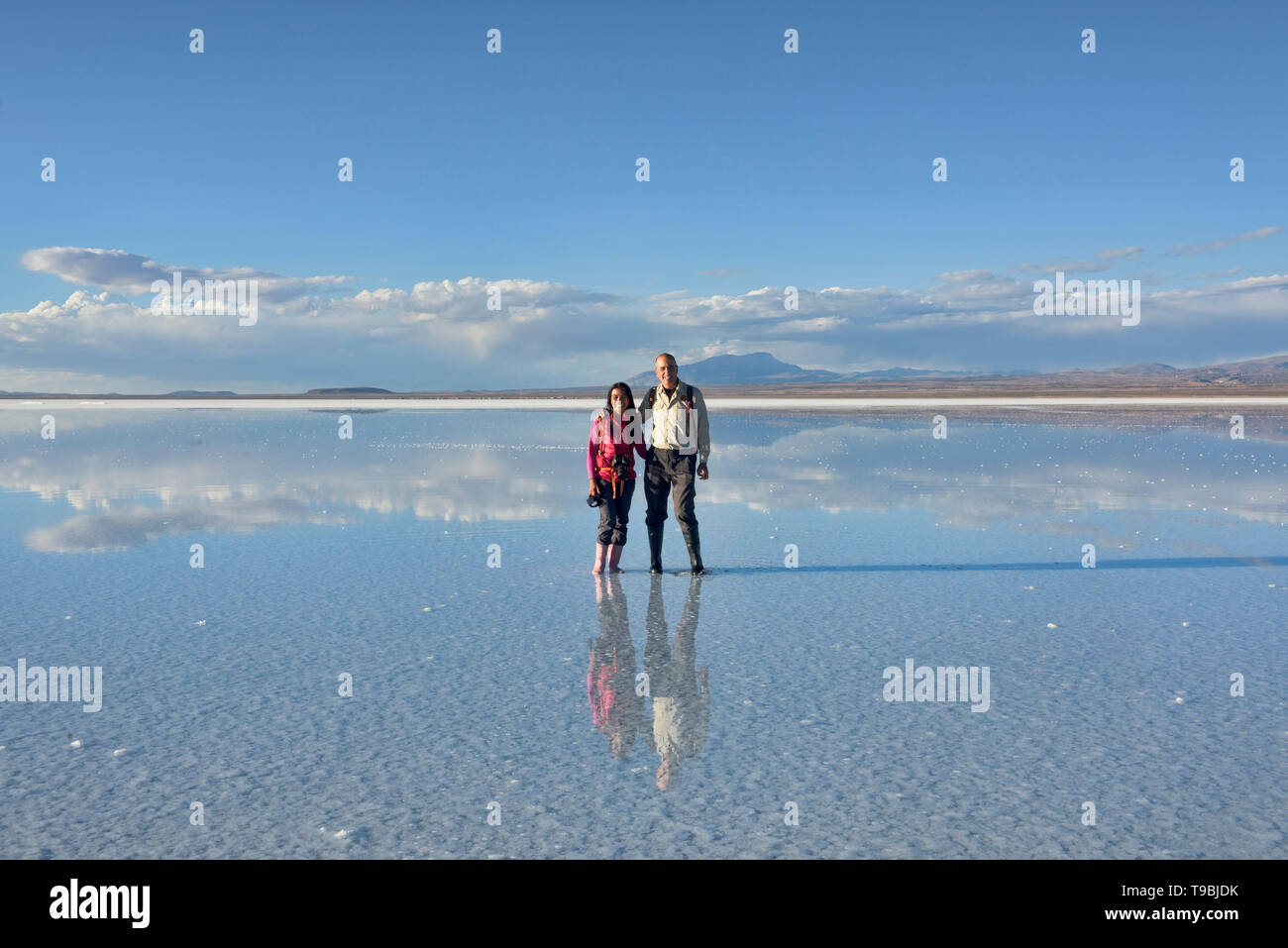 Tourists enjoying the world's largest mirror, the salt flats of the ...