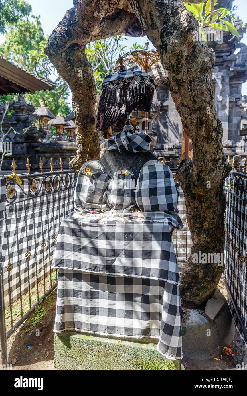 Ancient megaliths in black and white Saput Poleng cloths at altars at ...