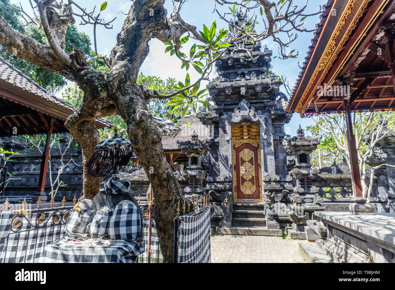 Ancient megaliths in black and white Saput Poleng cloths at altars at ...